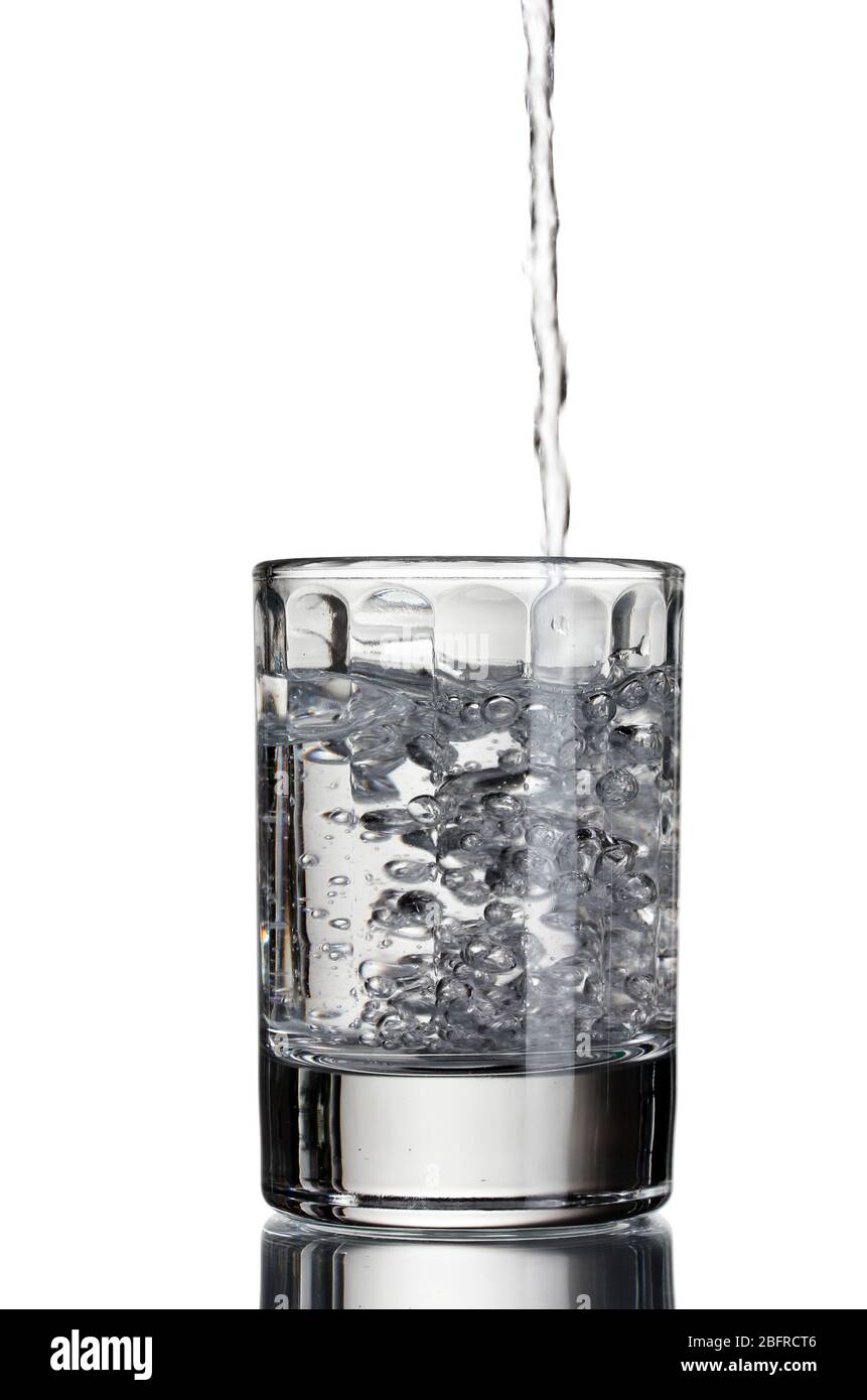 Vodka poured into a glass isolated on white Stock Photo - Alamy