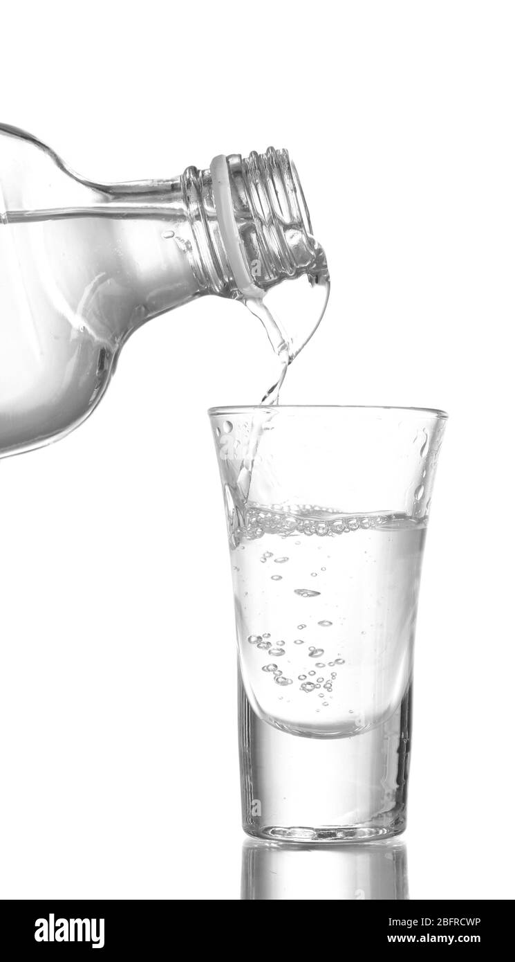 Vodka poured into a glass isolated on white Stock Photo - Alamy