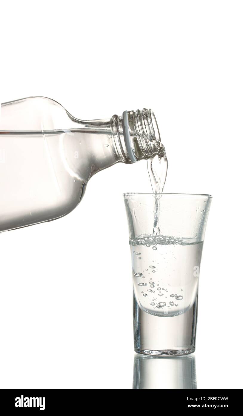 Vodka poured into a glass isolated on white Stock Photo - Alamy