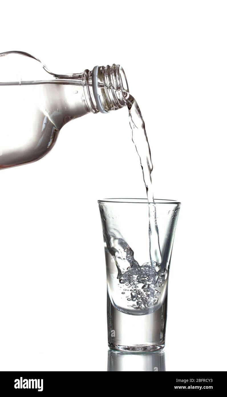 Vodka poured into a glass isolated on white Stock Photo - Alamy