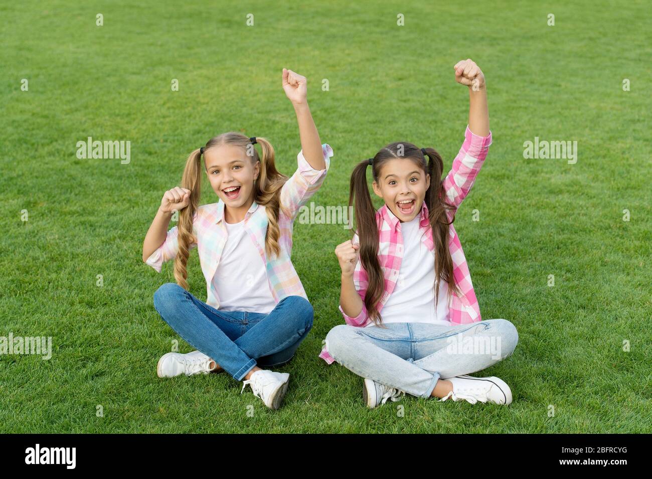 Lets celebrate. Happy kids make winner gestures. Little children ...