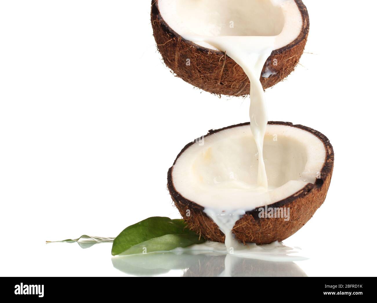 Coconut with coconut milk isolated on white Stock Photo - Alamy