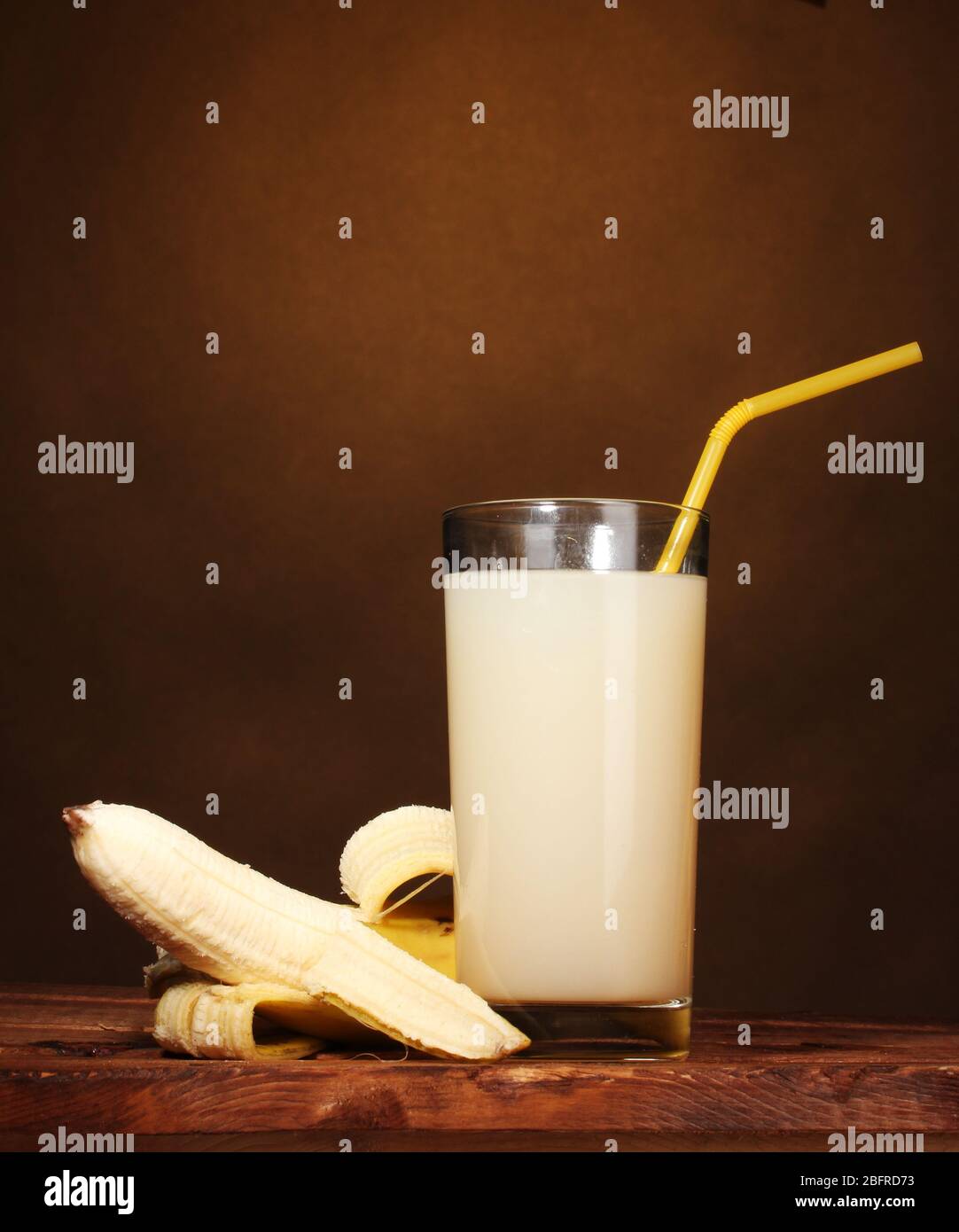 Banana juice with bananas on brown Stock Photo - Alamy