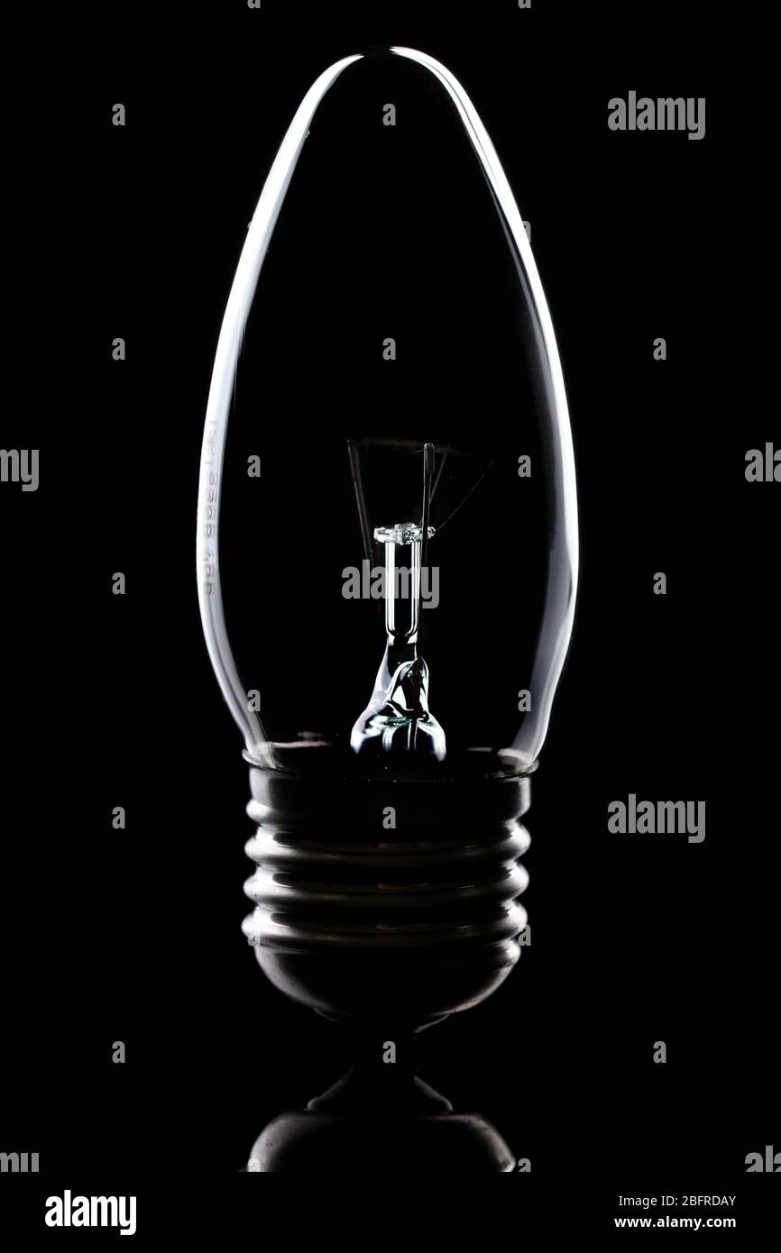 Light bulb on black background Stock Photo - Alamy