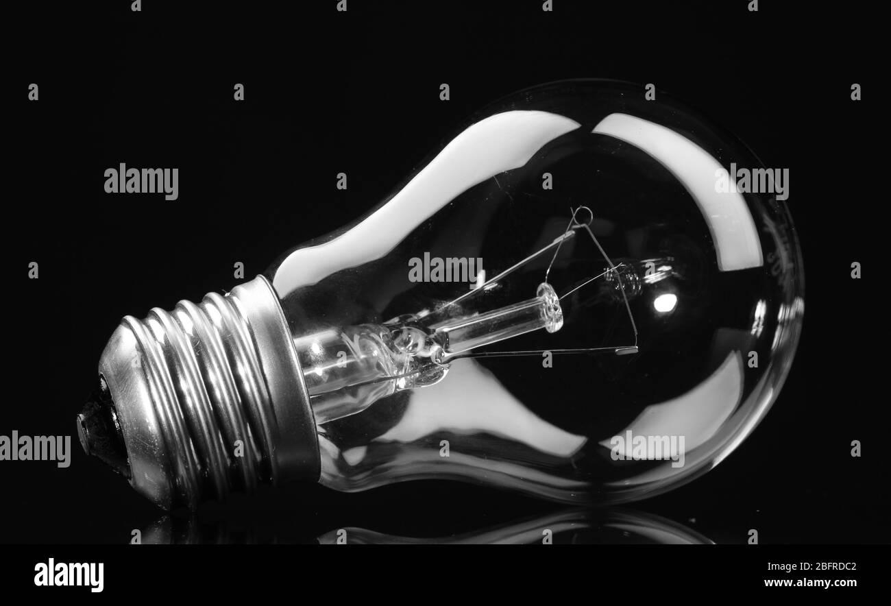 Light bulb on black background Stock Photo - Alamy