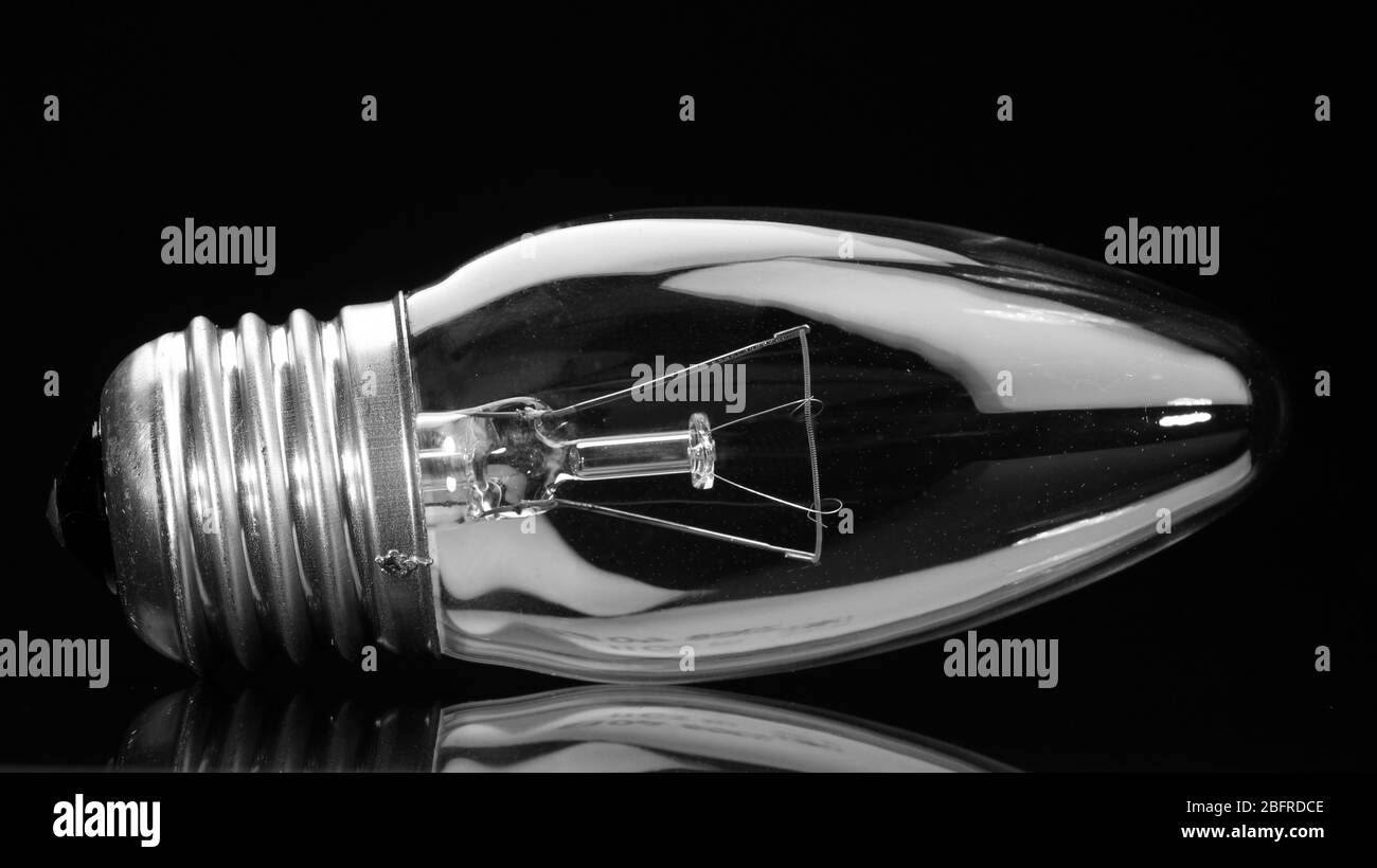 Light bulb on black background Stock Photo - Alamy