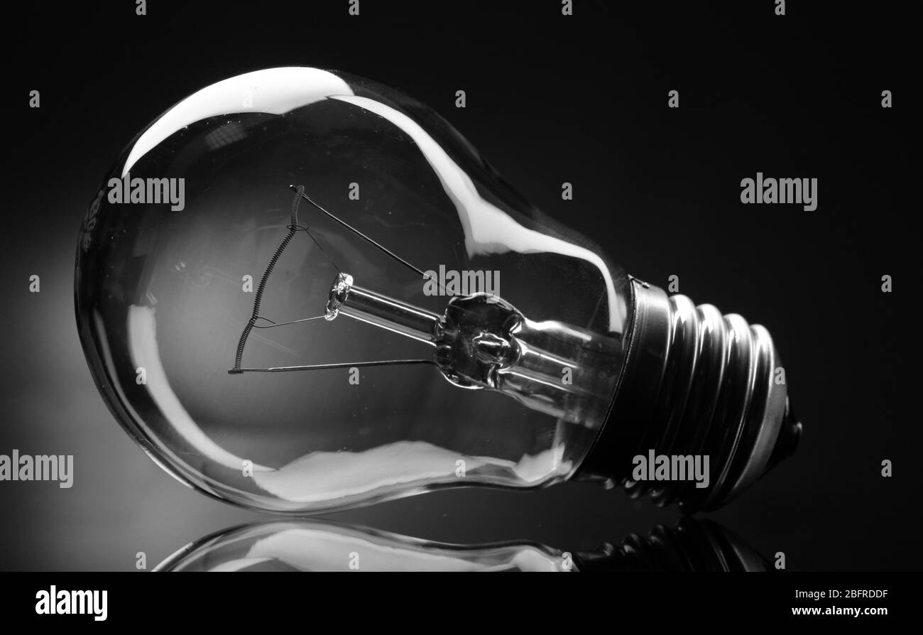 Light bulb on black background Stock Photo - Alamy