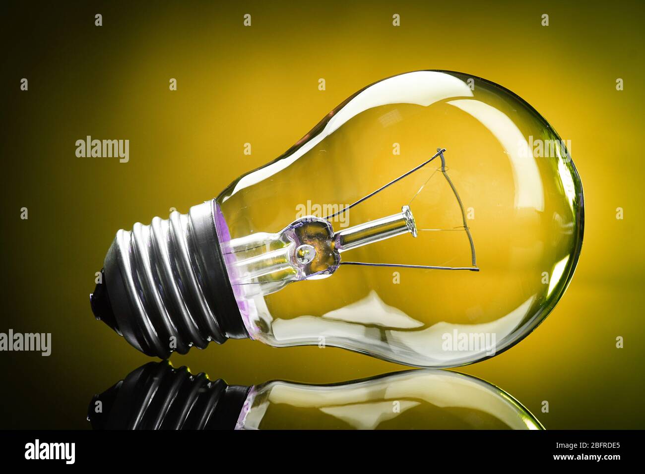 Light bulb on yellow background Stock Photo - Alamy