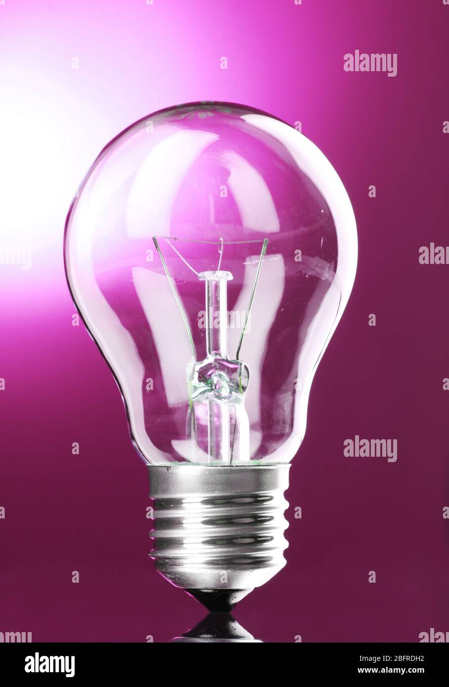 Light bulb on pink background Stock Photo - Alamy