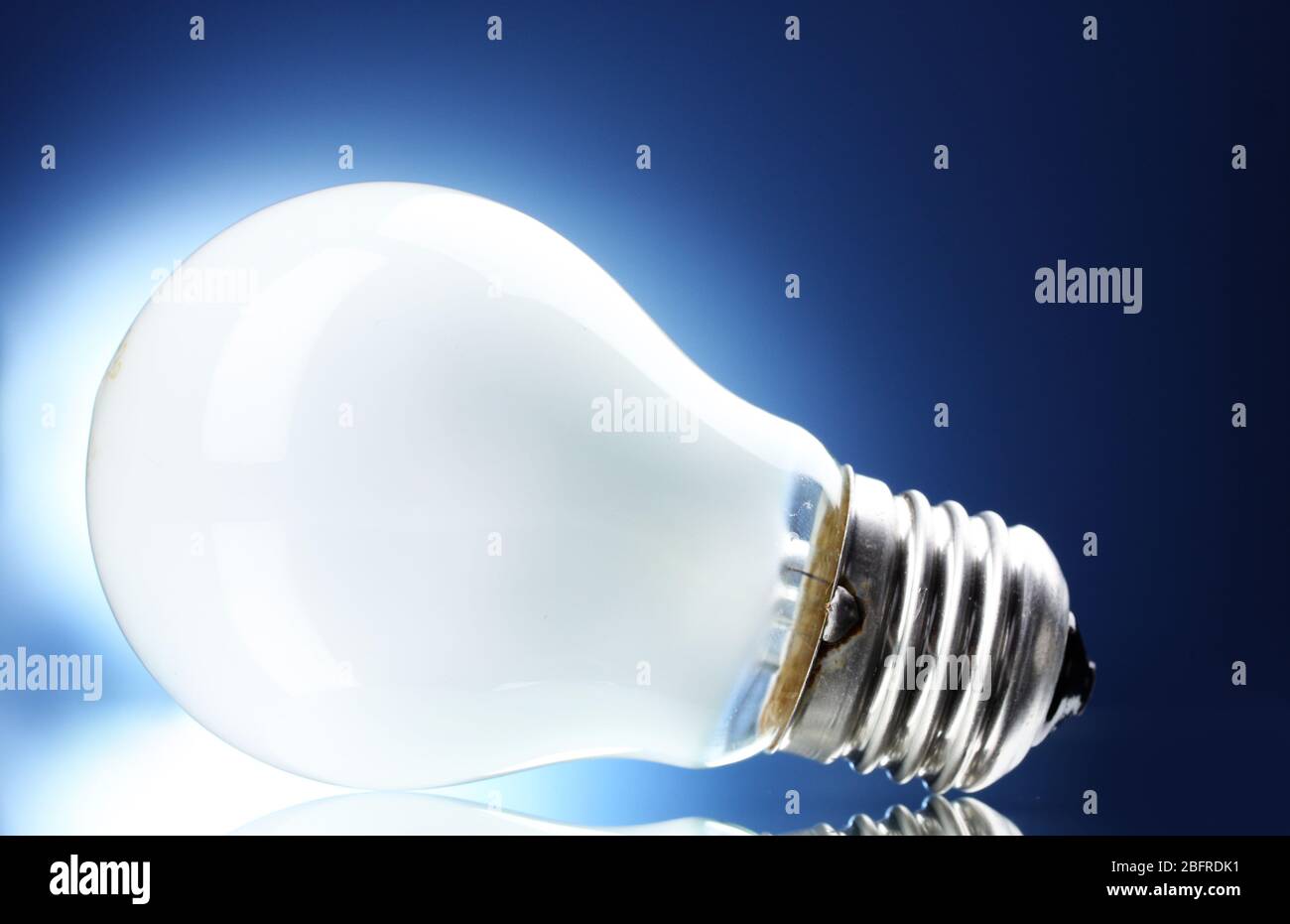 Light bulb on blue background Stock Photo - Alamy