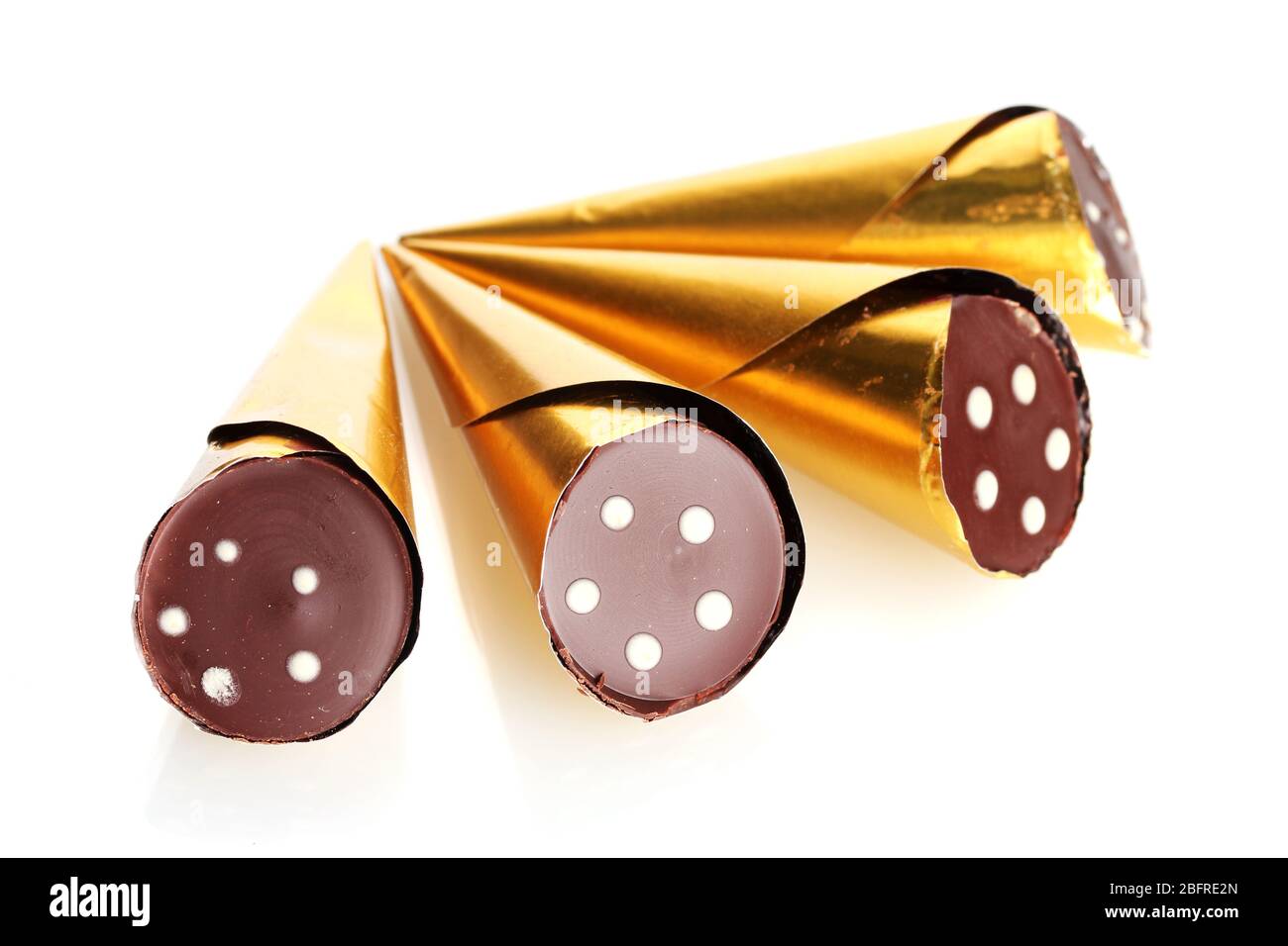 Сhocolate candy in the shape of a horn in the gold package isolated on ...