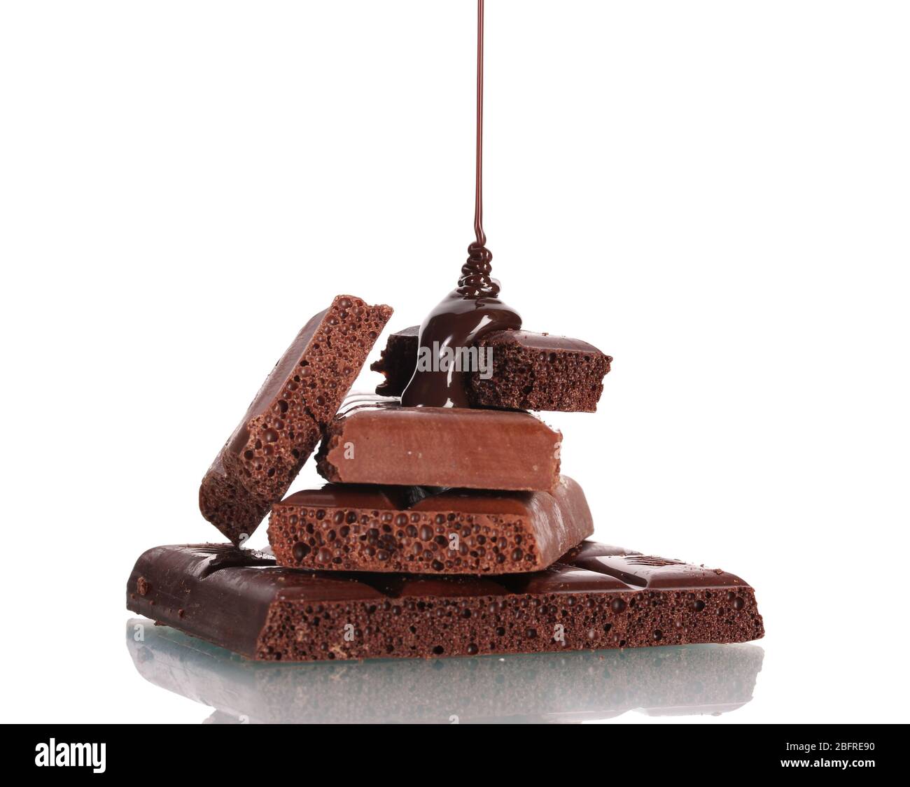 Slices of milk and dark chocolate bar poured chocolate isolated on ...