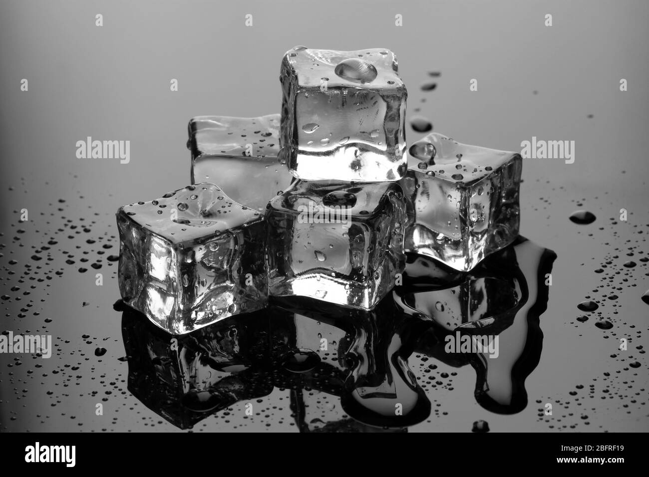 Melting ice cubes on grey background Stock Photo - Alamy