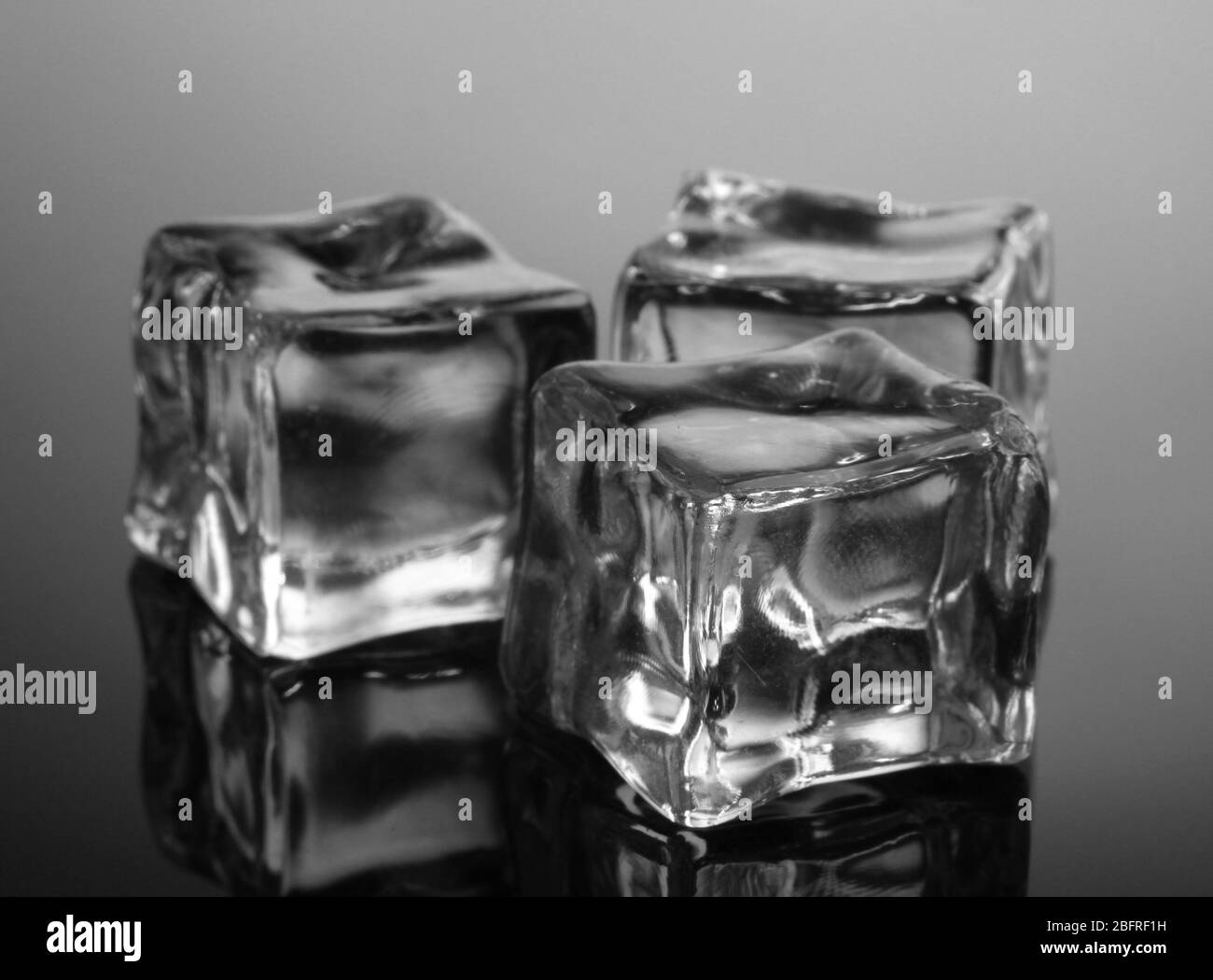 Ice cubes on grey background Stock Photo - Alamy