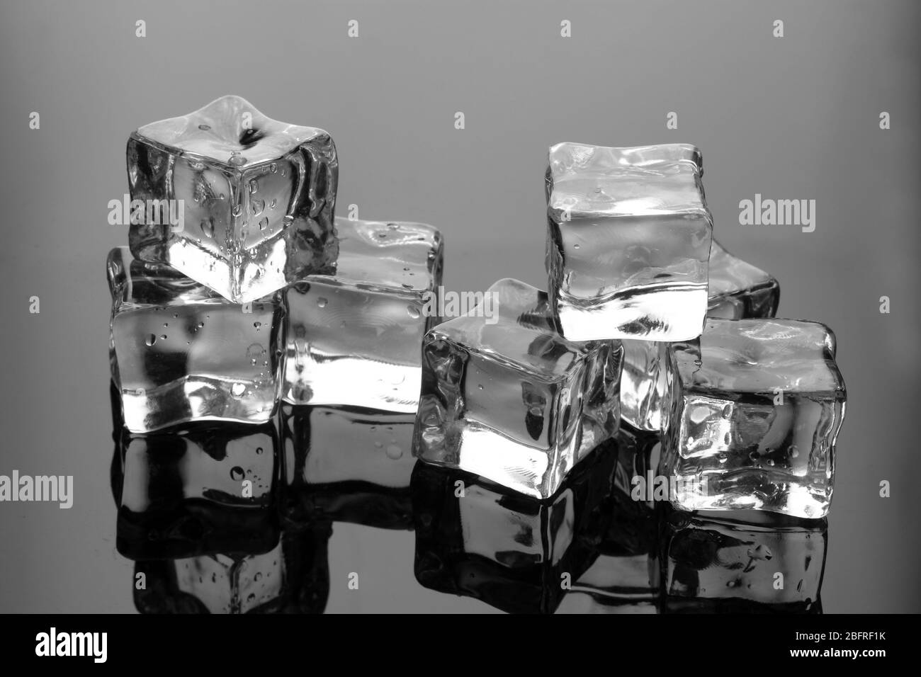 Ice cubes on grey background Stock Photo - Alamy