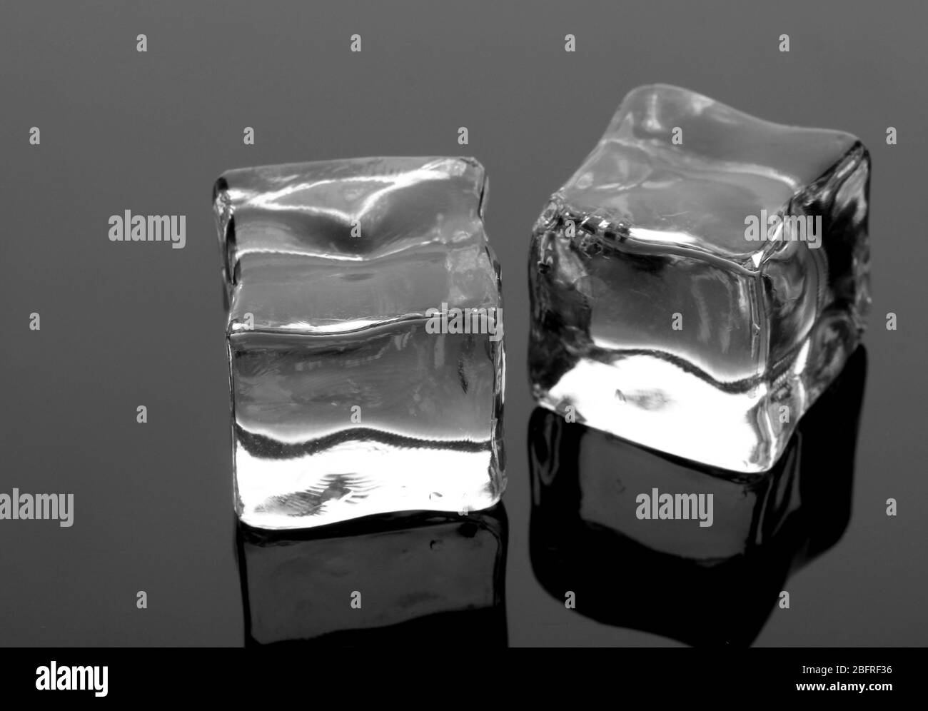 Ice cubes on grey background Stock Photo - Alamy