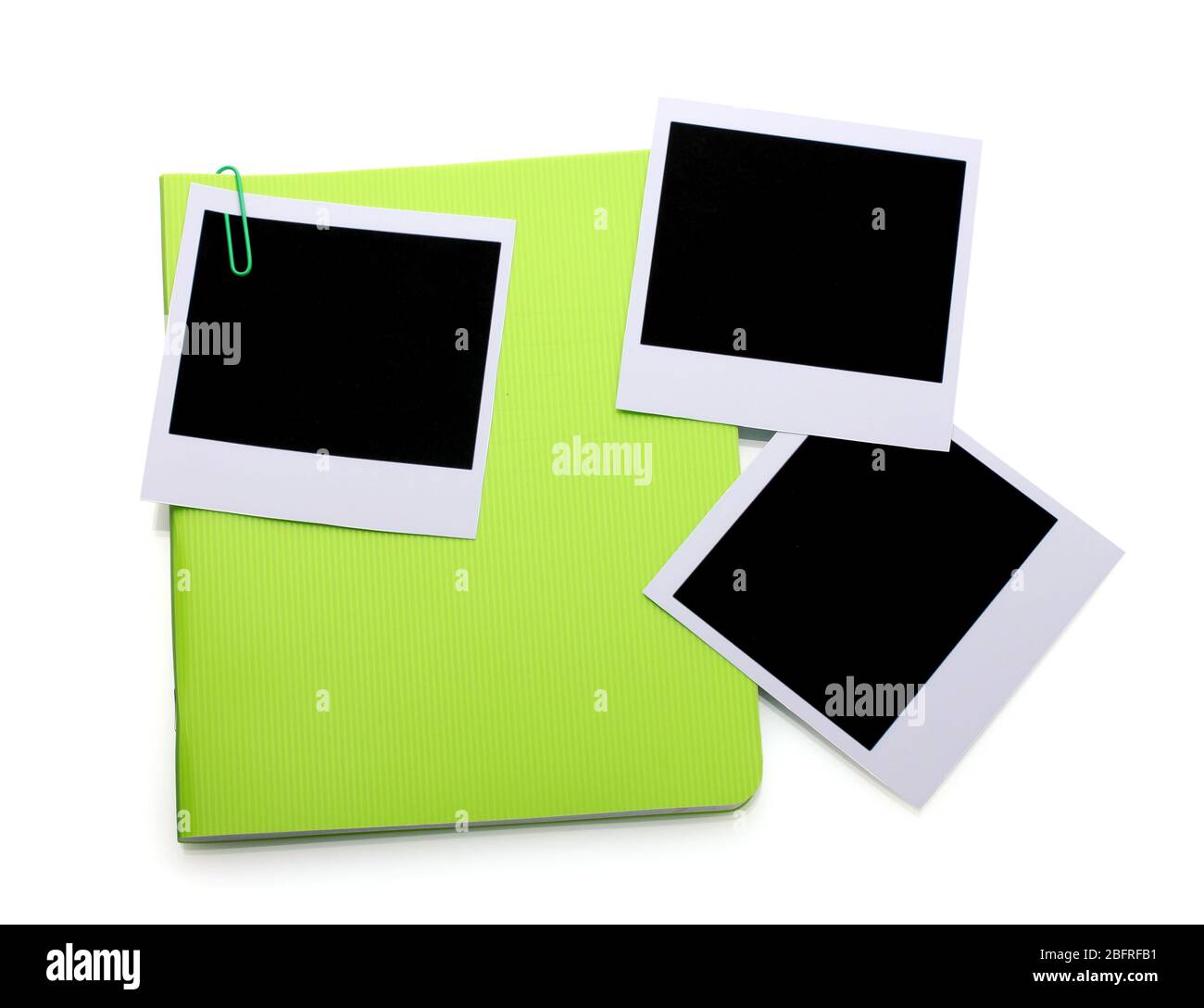 Photo papers and green notebook isolated on white Stock Photo - Alamy
