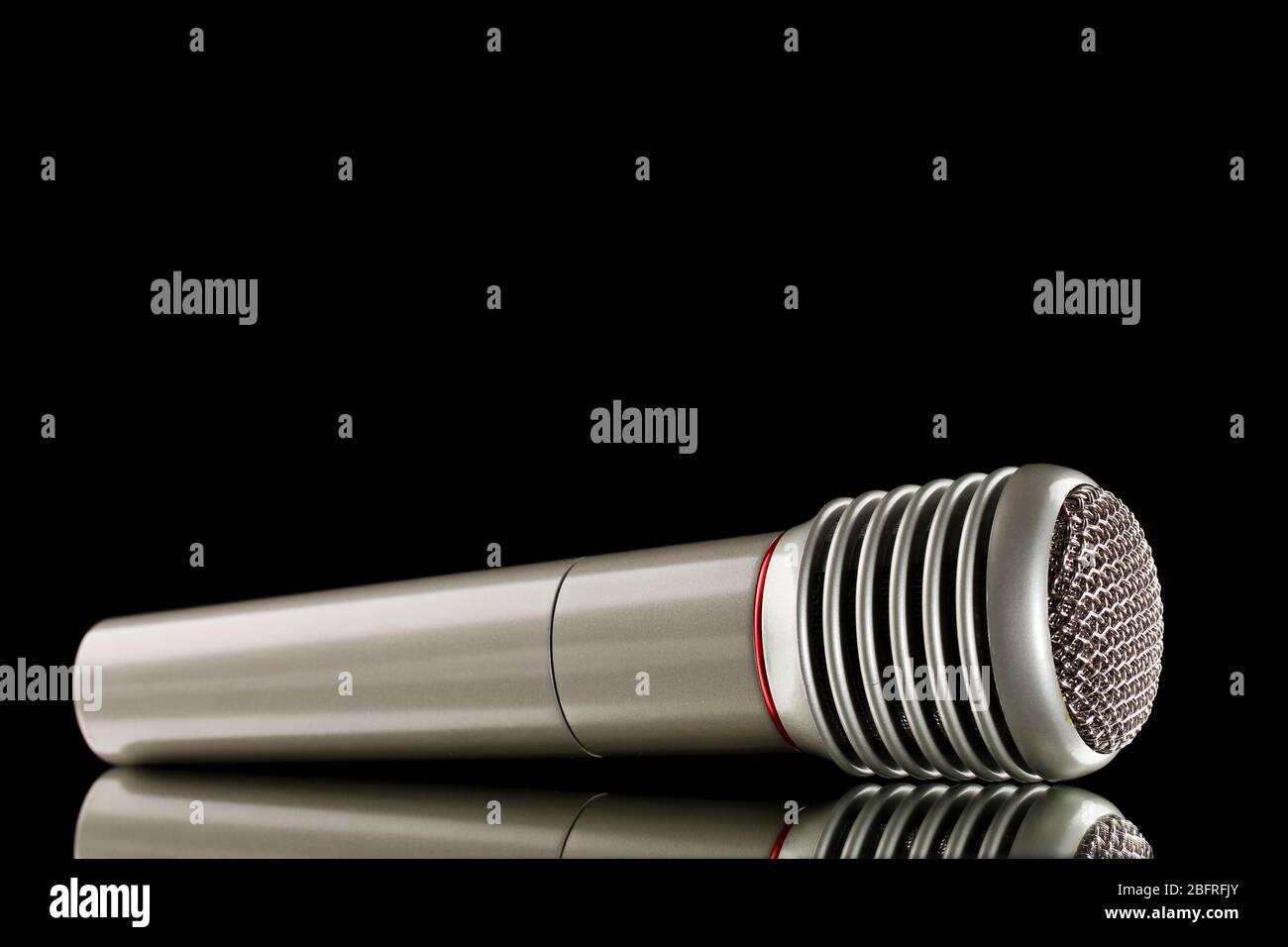 Grey microphone on black background Stock Photo - Alamy