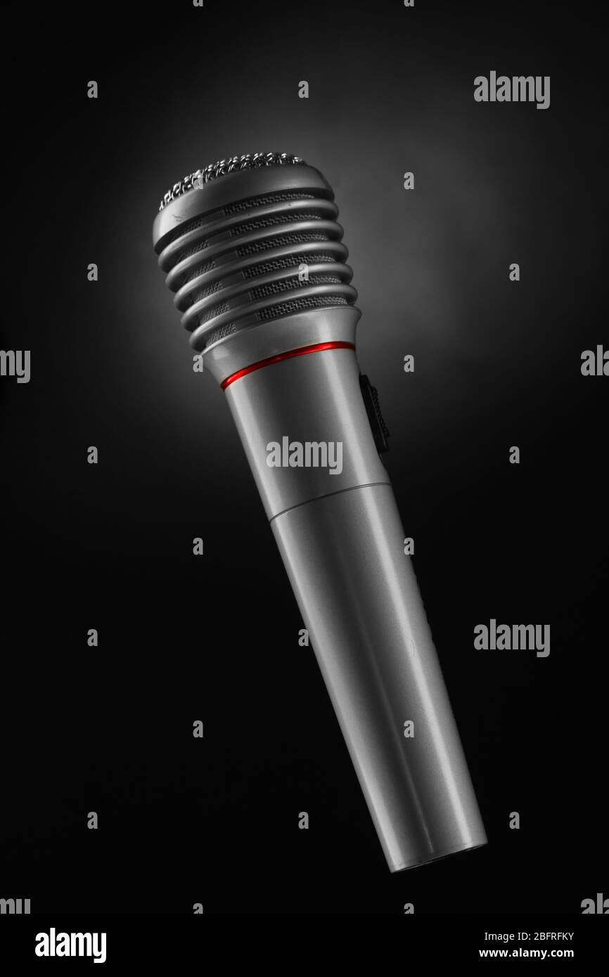 Shiny grey iron microphone on black background Stock Photo - Alamy