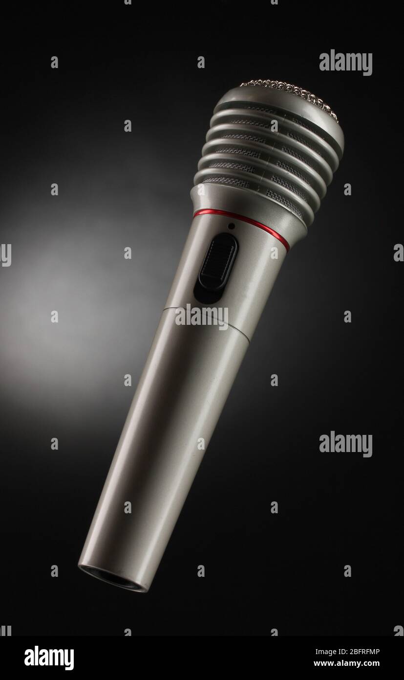 Shiny grey iron microphone on black background Stock Photo - Alamy