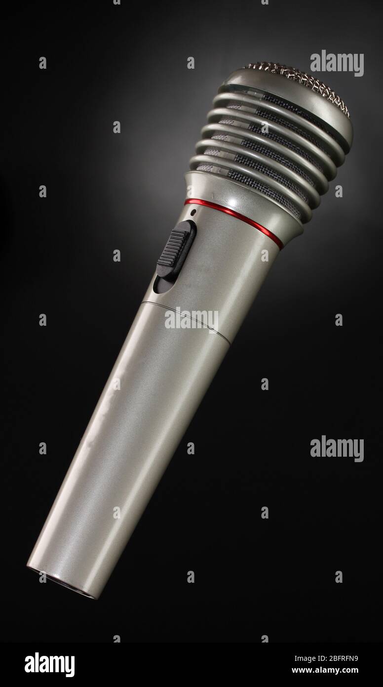 Shiny grey iron microphone on black background Stock Photo - Alamy