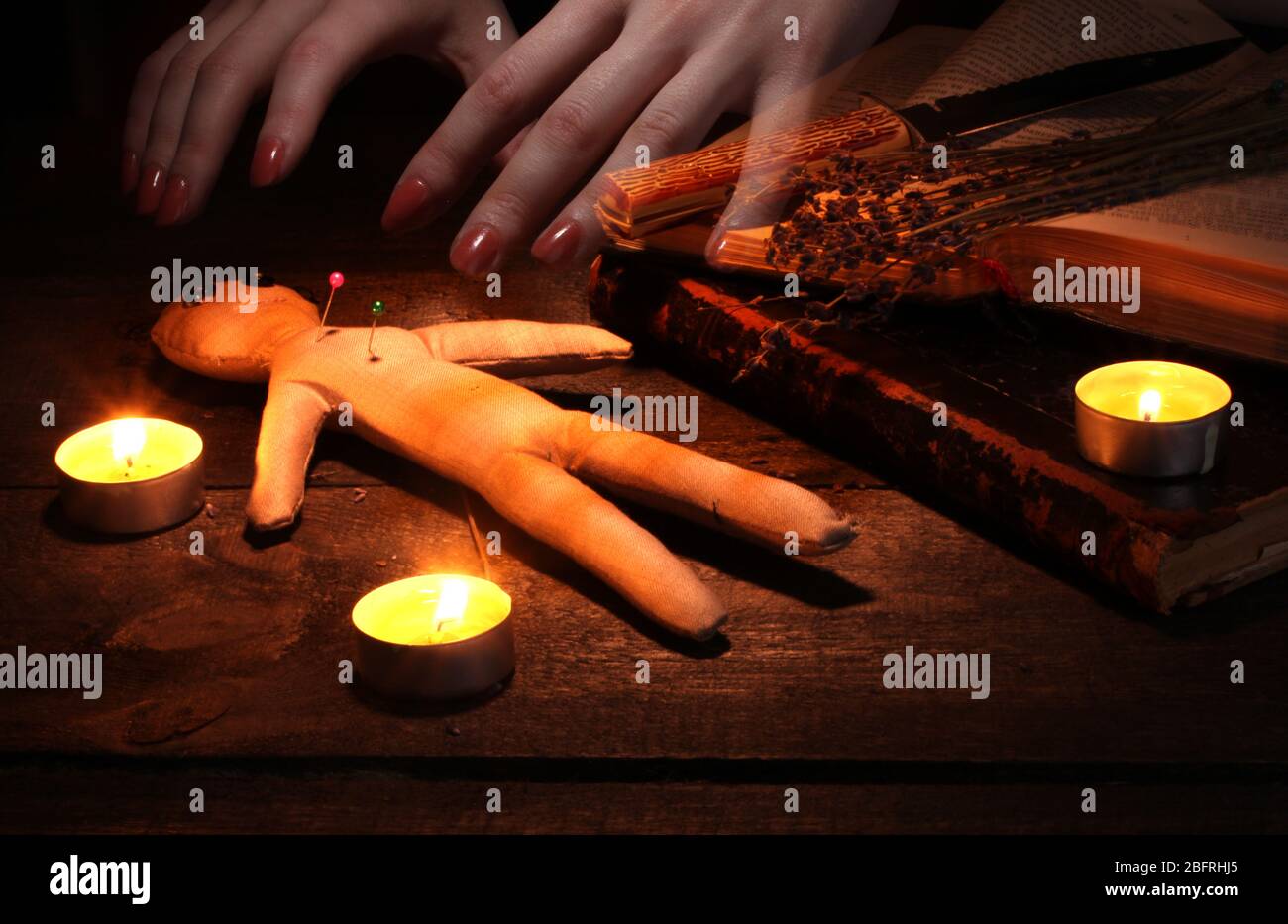 Voodoo doll boy on a wooden table in the candlelight Stock Photo - Alamy