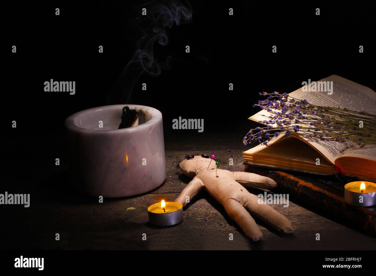 Voodoo doll boy on a wooden table in the candlelight Stock Photo - Alamy