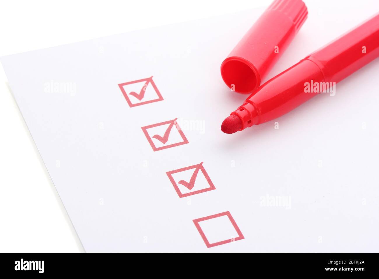 Checklist and red marker closeup Stock Photo - Alamy