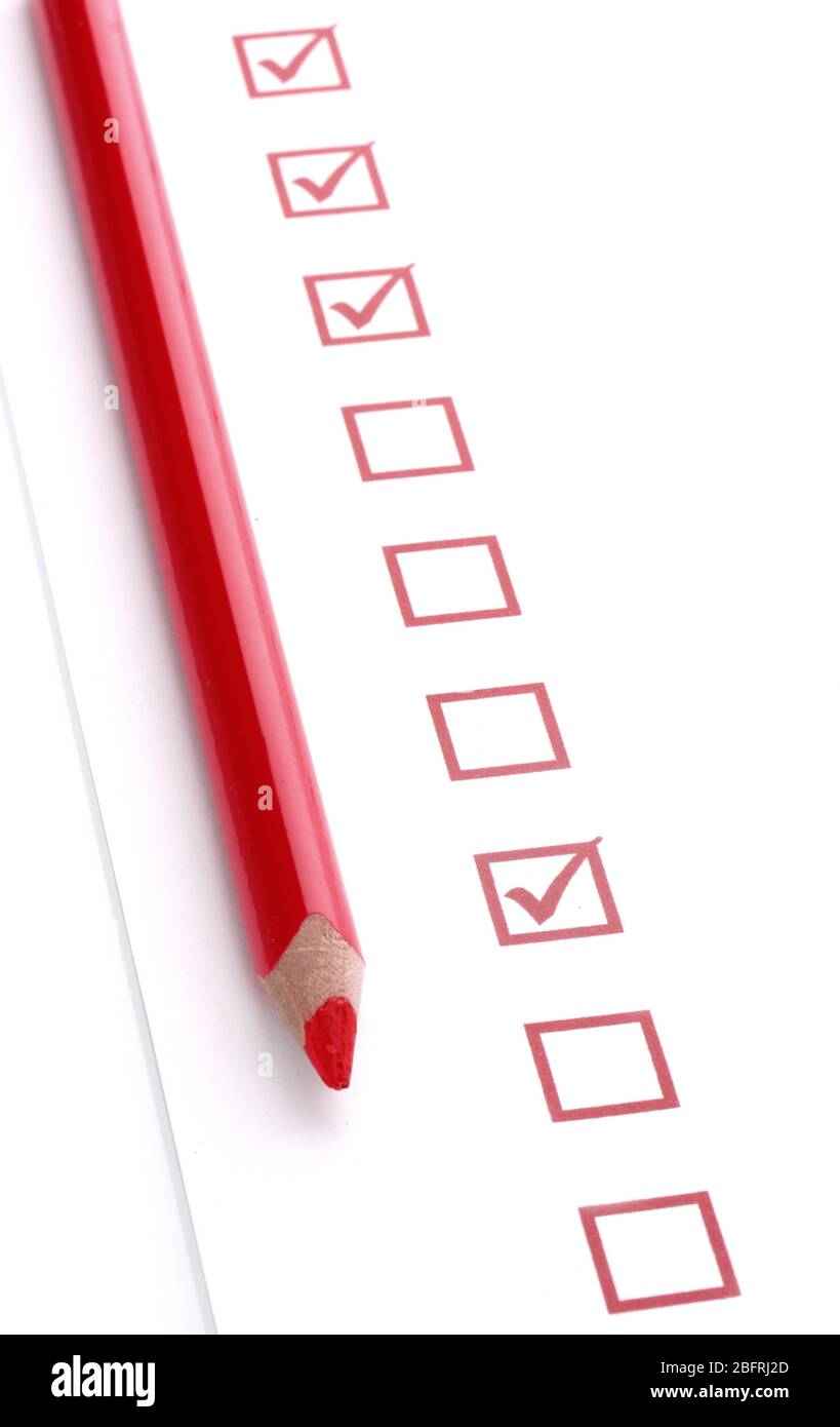 Checklist and red pencil closeup Stock Photo - Alamy