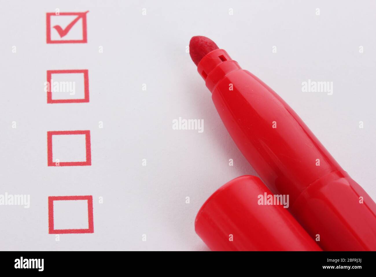 Checklist and red marker closeup Stock Photo - Alamy