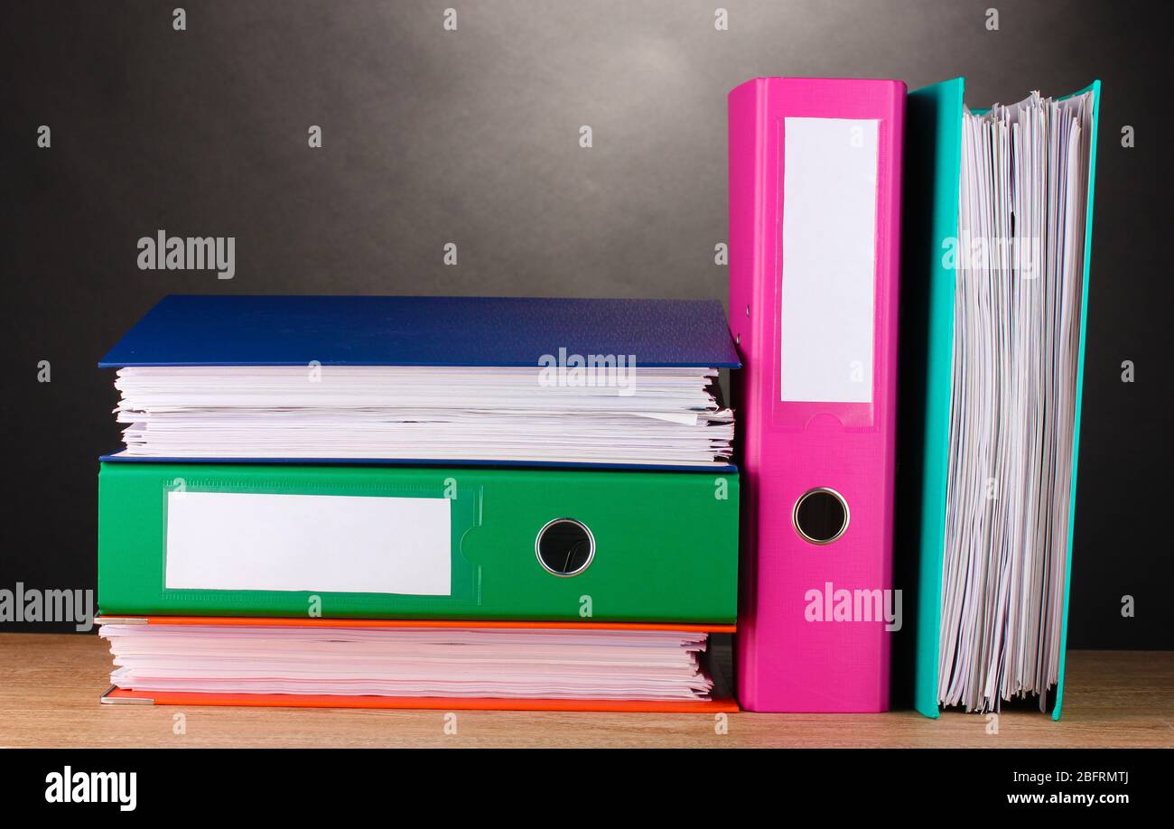 bright office folders on wooden table on grey background Stock Photo ...