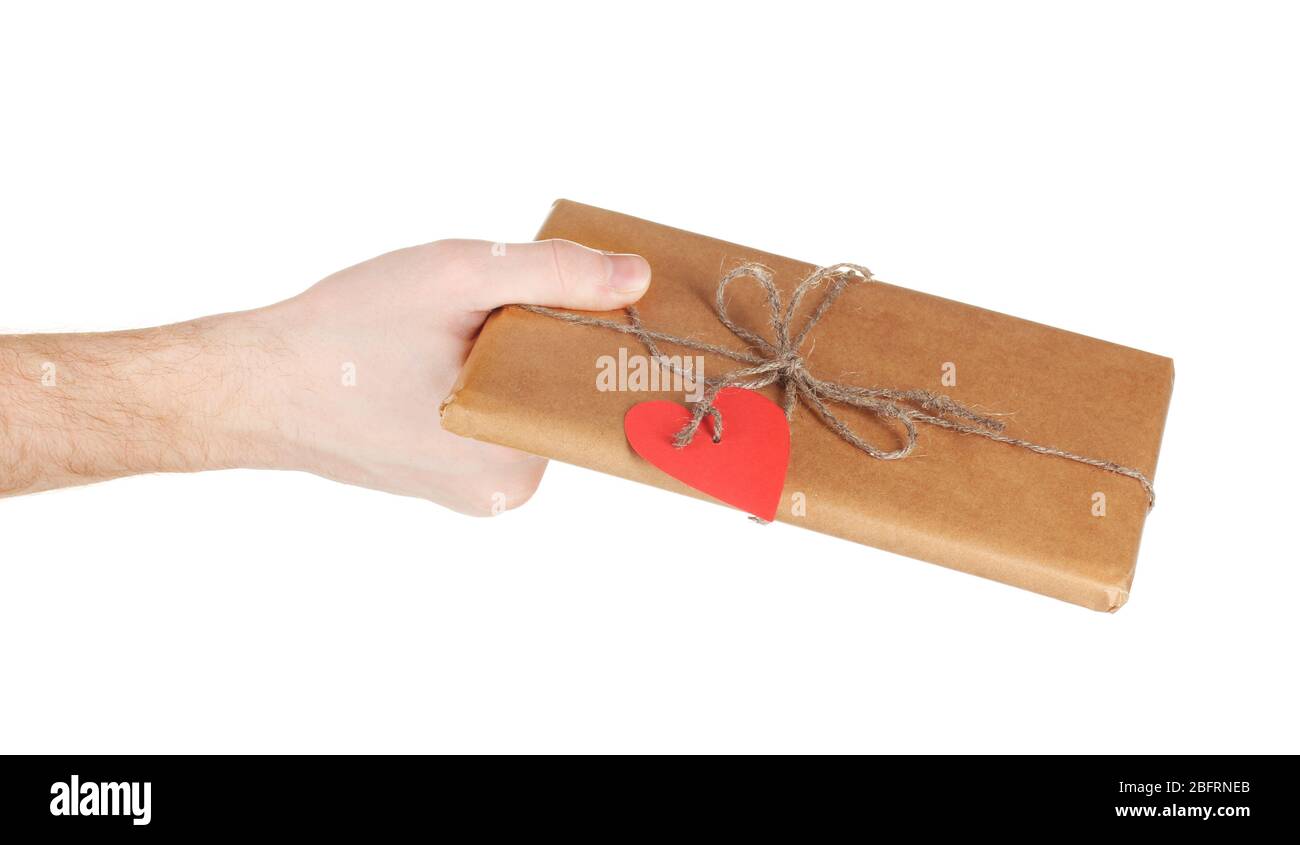 Parcel with blank heart-shaped label in man's hand isolated on white ...