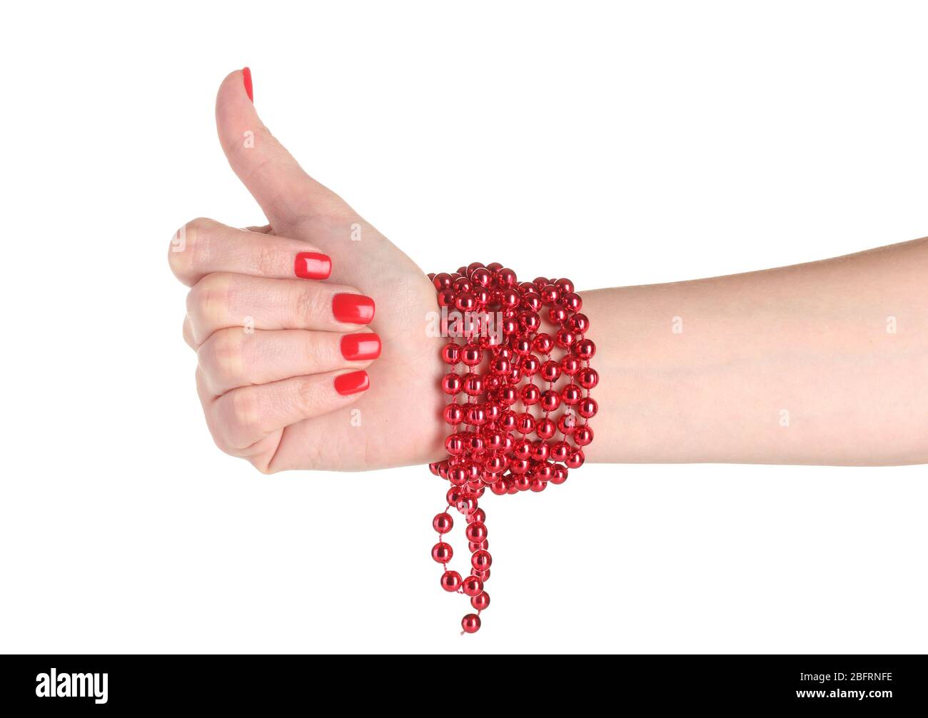 Thumbs up hand gesture and red beads on wrist isolated on white Stock ...