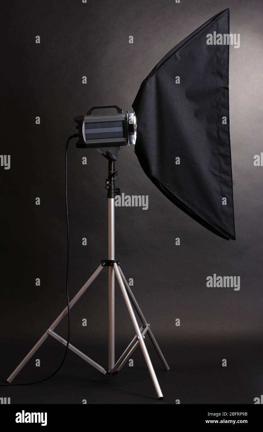 Studio flash with soft-box on black studio background Stock Photo - Alamy