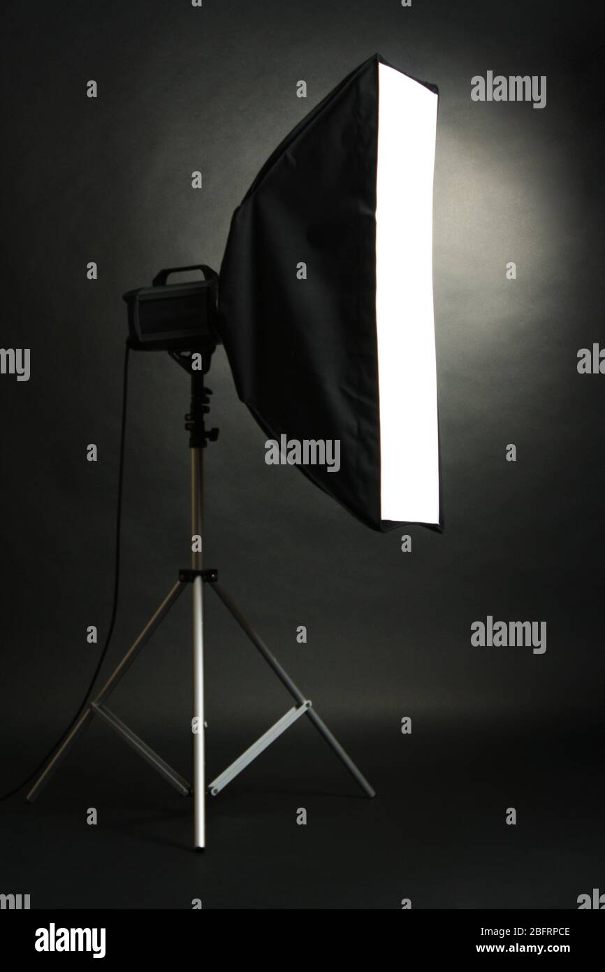 Studio flash with soft-box on black studio background Stock Photo - Alamy