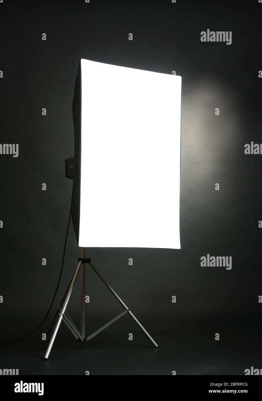 Studio flash with soft-box on black studio background Stock Photo - Alamy