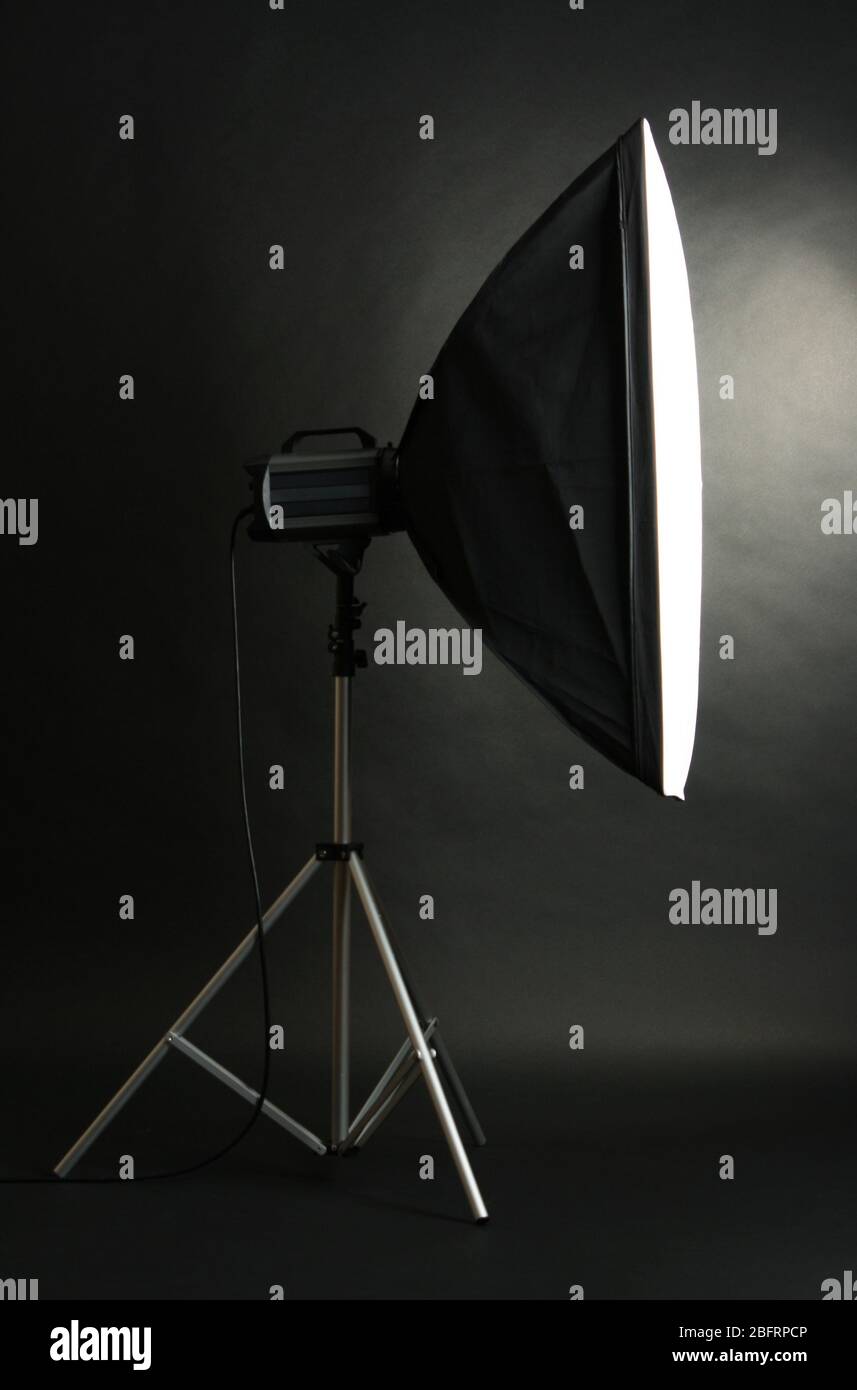 Studio flash with soft-box on black studio background Stock Photo - Alamy