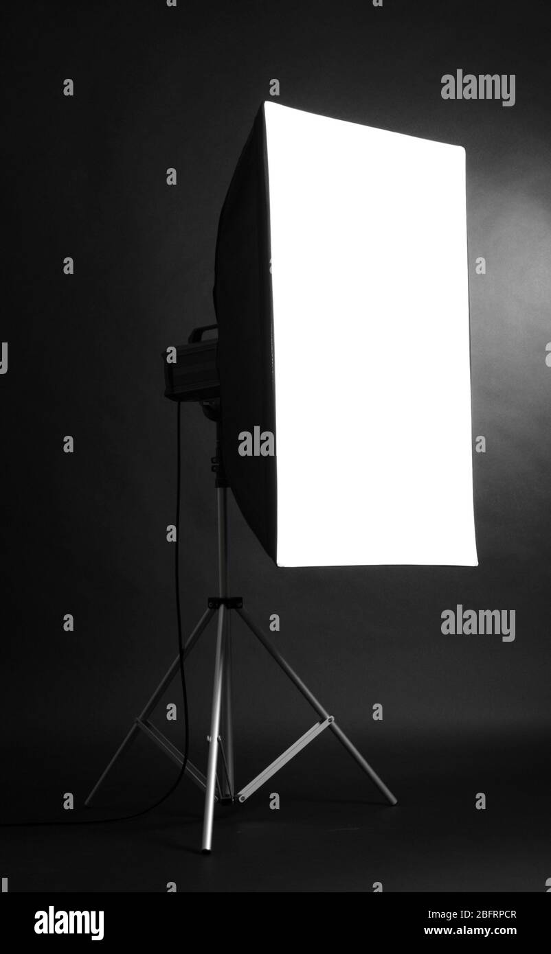 Studio flash with soft-box on black studio background Stock Photo - Alamy