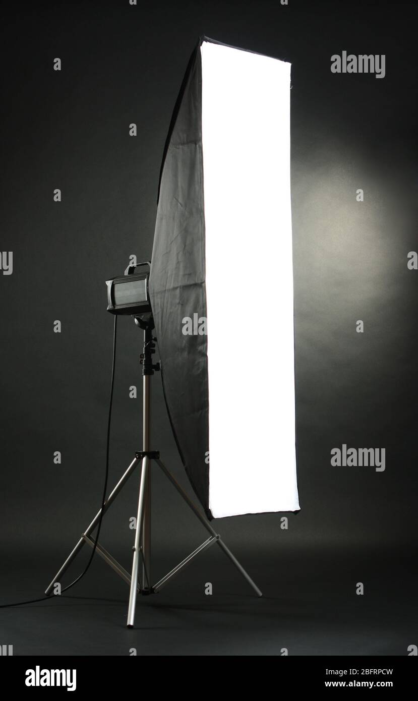 Studio flash with soft-box on black studio background Stock Photo - Alamy