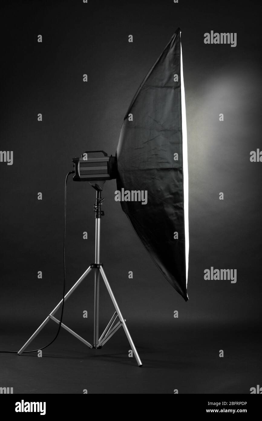Studio flash with soft-box on black studio background Stock Photo - Alamy