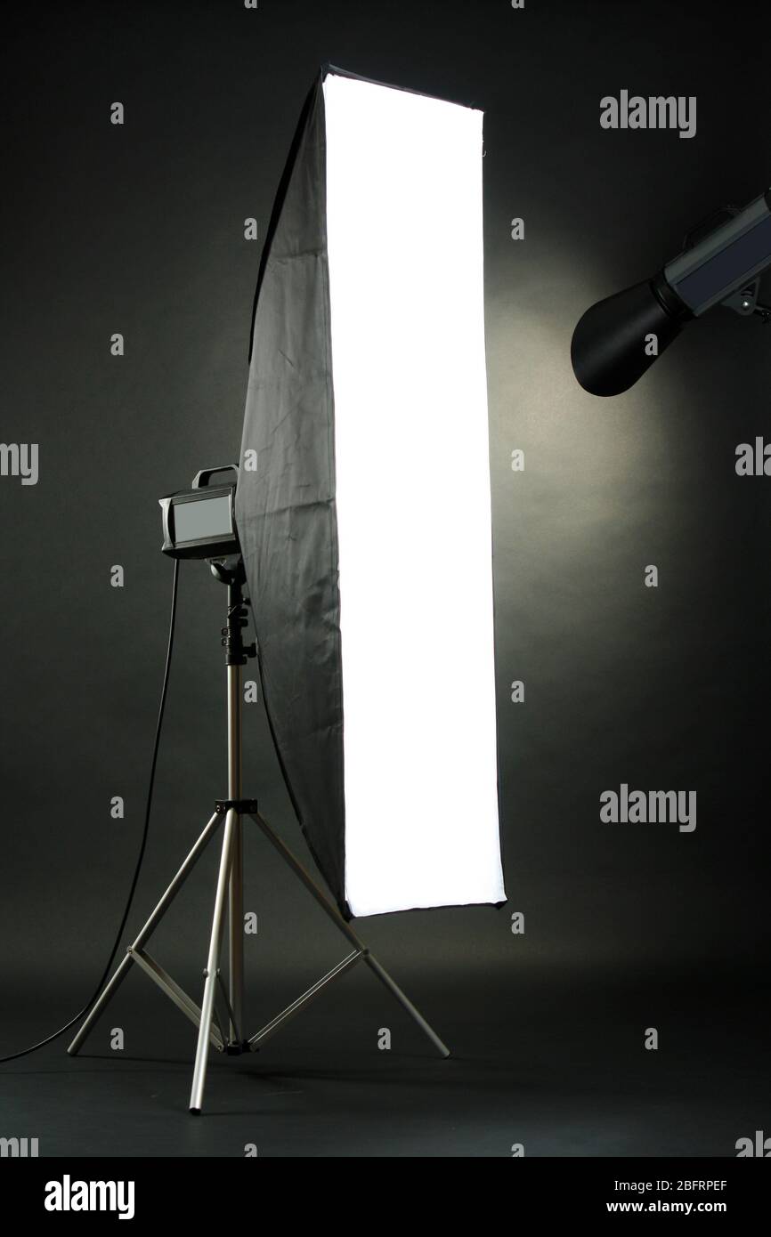 Studio flash with soft-box on black studio background Stock Photo - Alamy