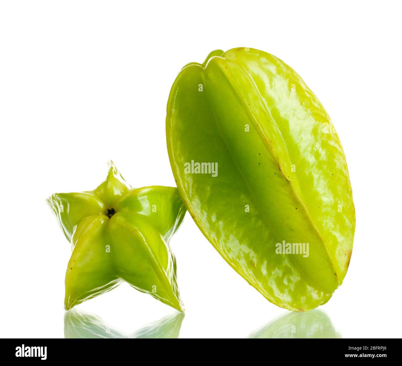 two fresh carambola fruits isolated on white Stock Photo - Alamy