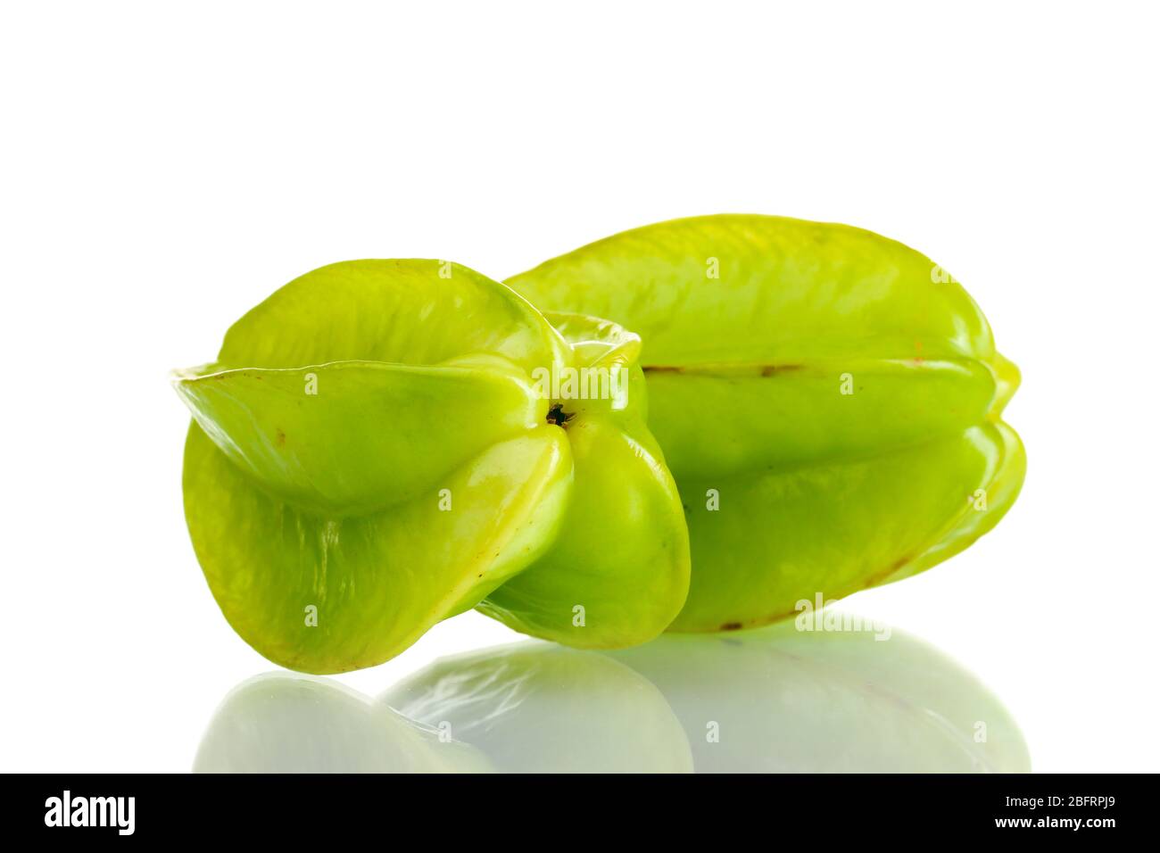 two fresh carambola fruits isolated on white Stock Photo - Alamy