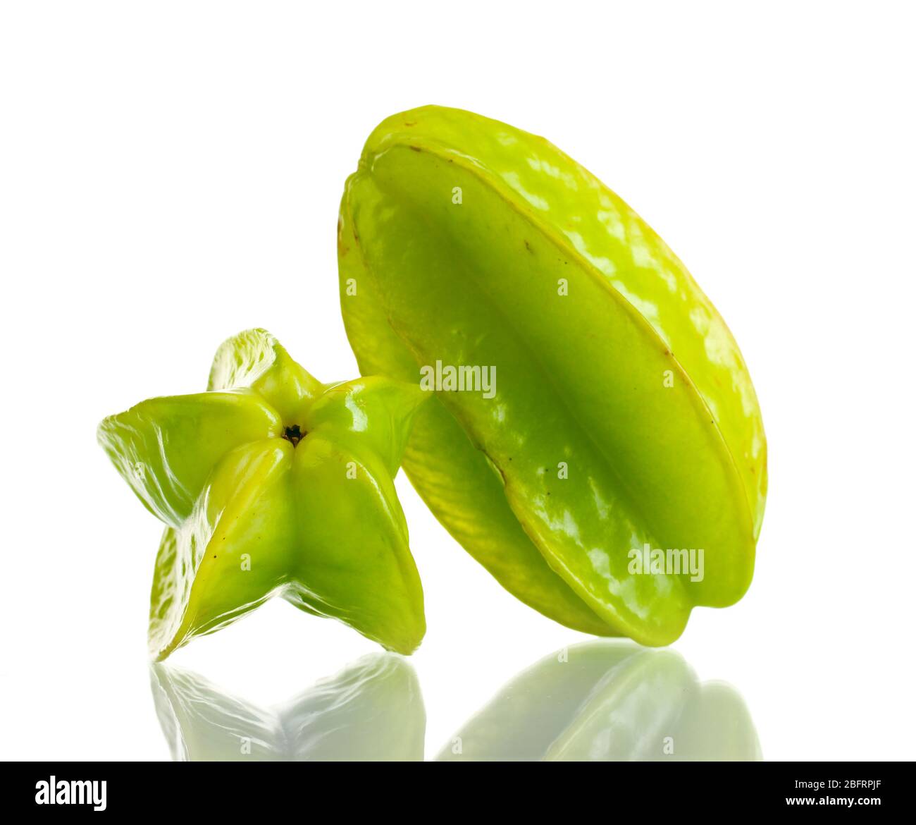 two fresh carambola fruits isolated on white Stock Photo - Alamy