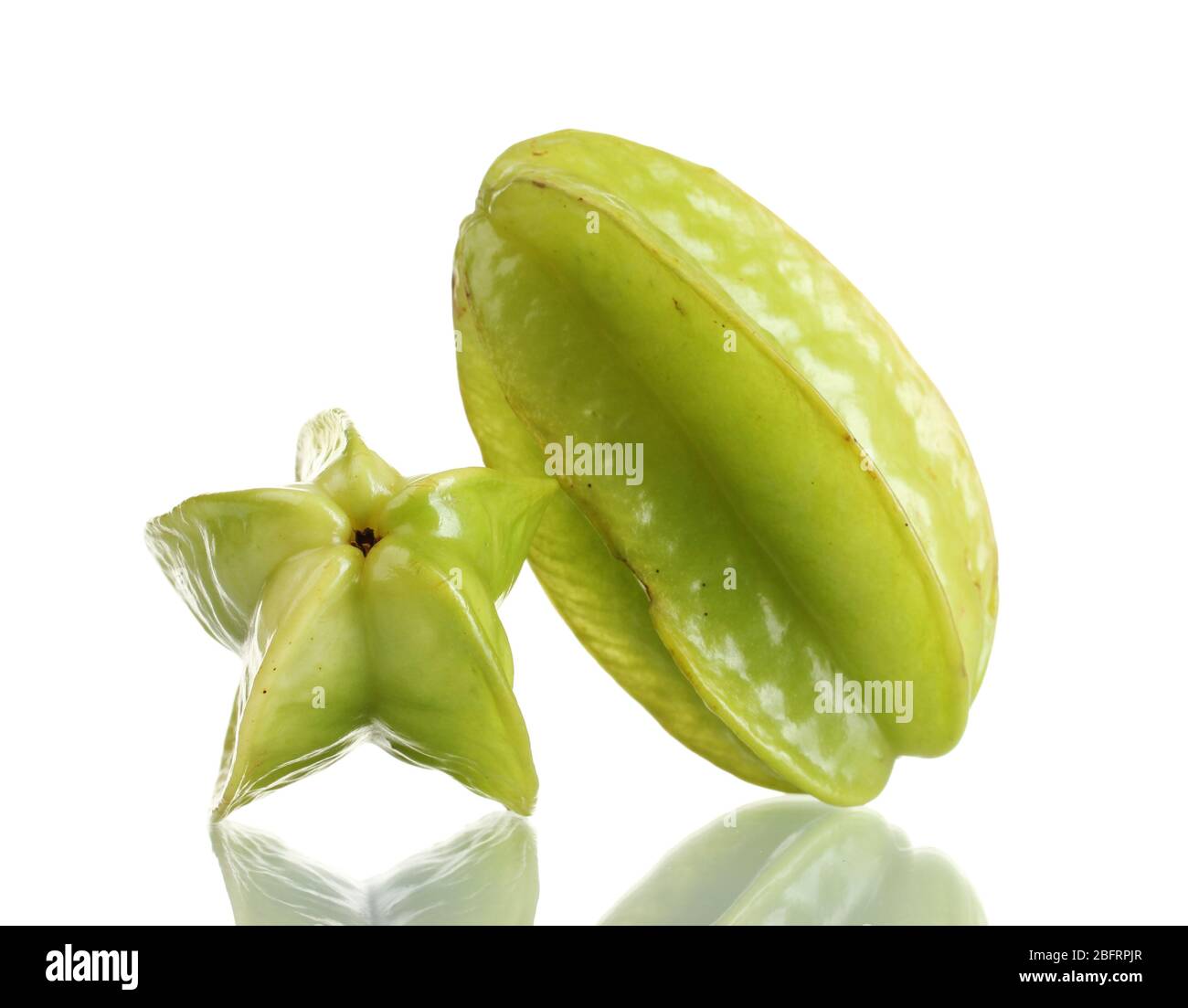 two fresh carambola fruits isolated on white Stock Photo - Alamy