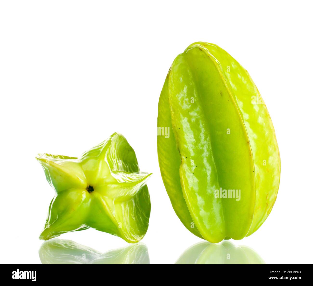 two fresh carambola fruits isolated on white Stock Photo - Alamy