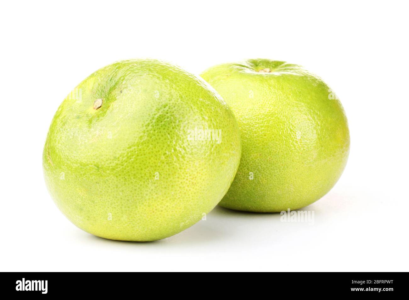 two green grapefruits isolated on white Stock Photo - Alamy
