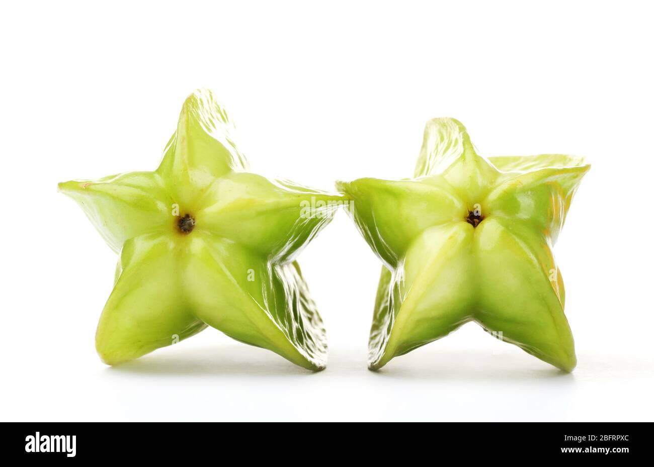 two fresh carambola fruits isolated on white Stock Photo - Alamy