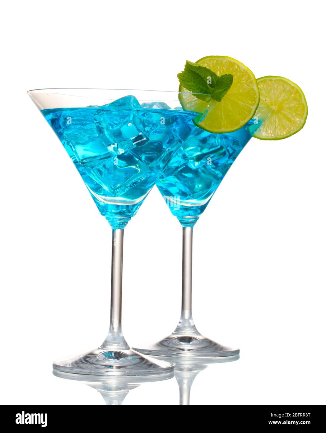 Blue cocktail in martini glasses with ice isolated on white Stock Photo ...