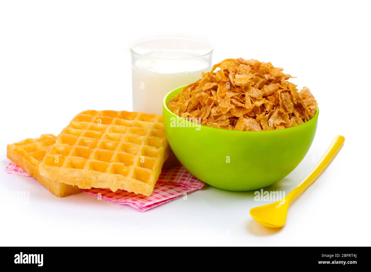 tasty cornflakes in green bowl and glass of milk isolated on white ...